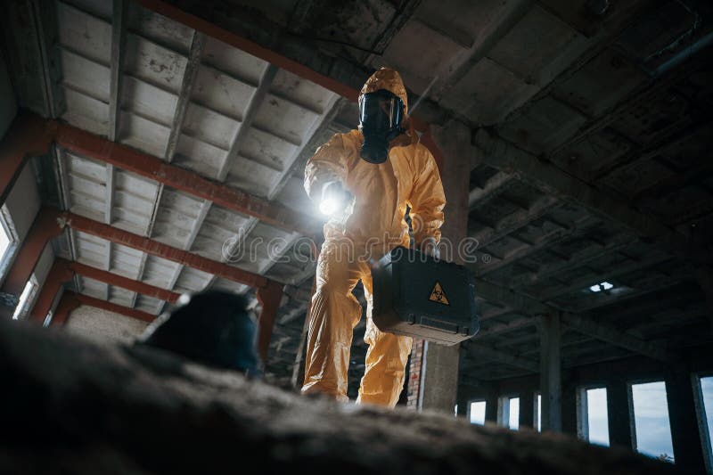Looking Below at the Object. Man Dressed in Chemical Protection Suit in ...