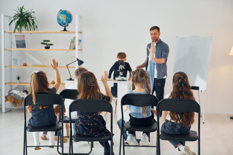 Looking at the Boy with Microscope that is on the Table. Group of ...