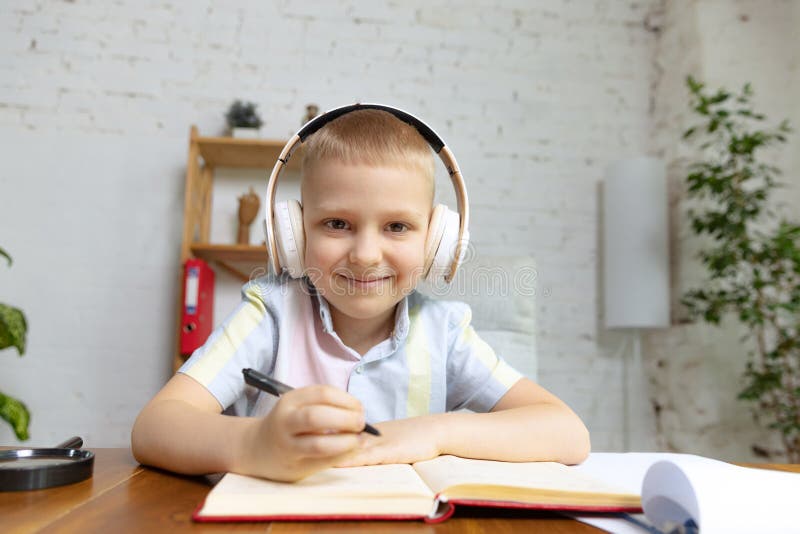 Happy School Age Kid Sitting at Home and Doing Homework at Home ... Happy School Age Kid Sitting at Home and Doing Homework at Home ...