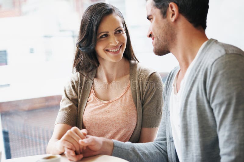 Looking Deep into Each Others Eyes. a Young Couple Grabbing a Cup of ...