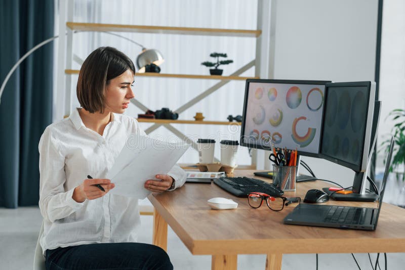 Looking at Display. Female Designer Working in the Office by Using PC ...