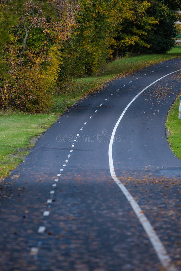 Looking Down a Bike Path Dressed in Autumn Leaves.. Stock Image - Image ...