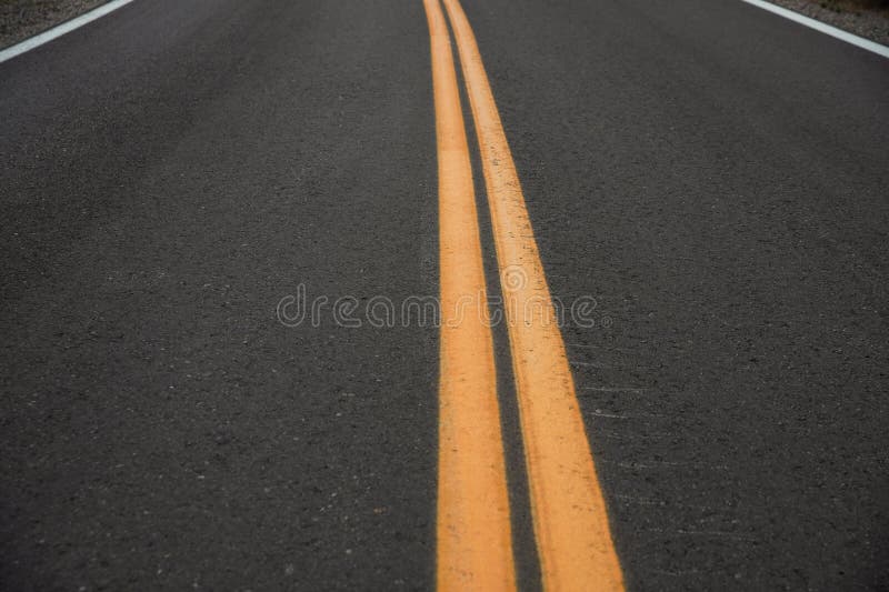 Looking Down at Double Yellow Lines on Paved Road Stock Image - Image ...