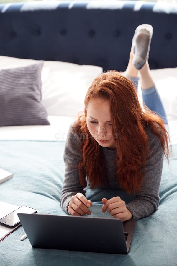 Looking Down on Female College Student Lying on Bed Working on Laptop ...