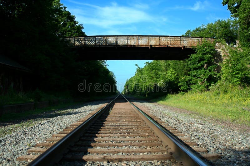 Looking Down Railroad Tracks with Bridge Stock Image - Image of blue ...