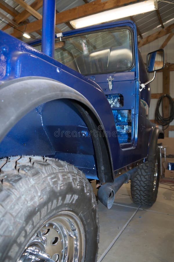 Restored Blue Jeep CJ5 in Garage Stock Photo - Image of door, mountains ...