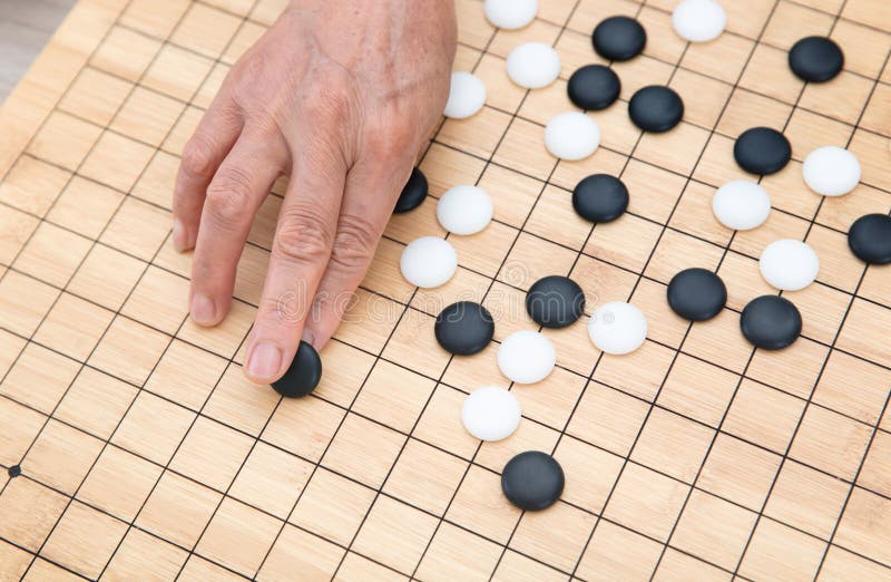 Looking Down Shot Holding Go Pieces on the Chessboard Stock Photo ...