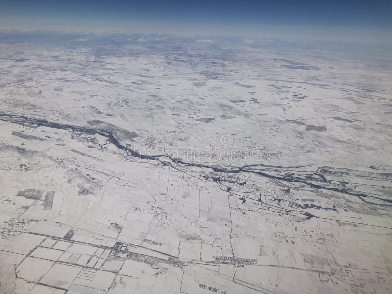 Looking Down from the Sky, the Earth Covered with Snow and White are ...