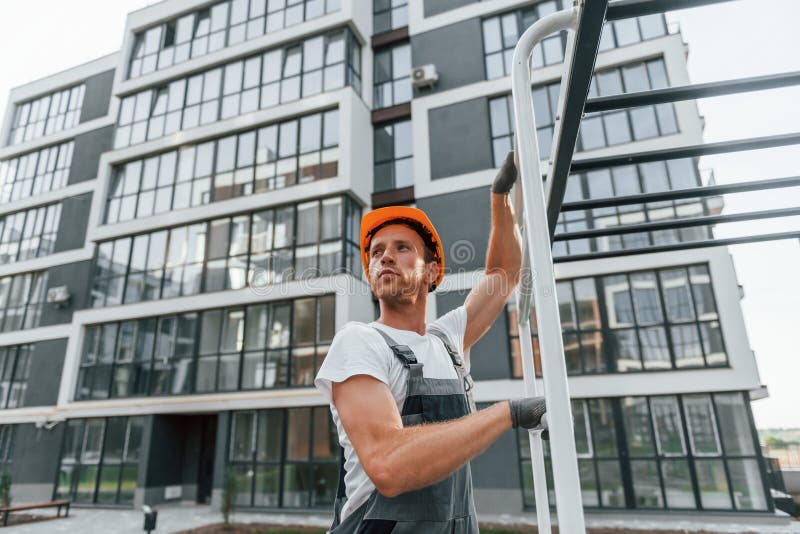 Looking Far Away. Young Man Working in Uniform at Construction at ...