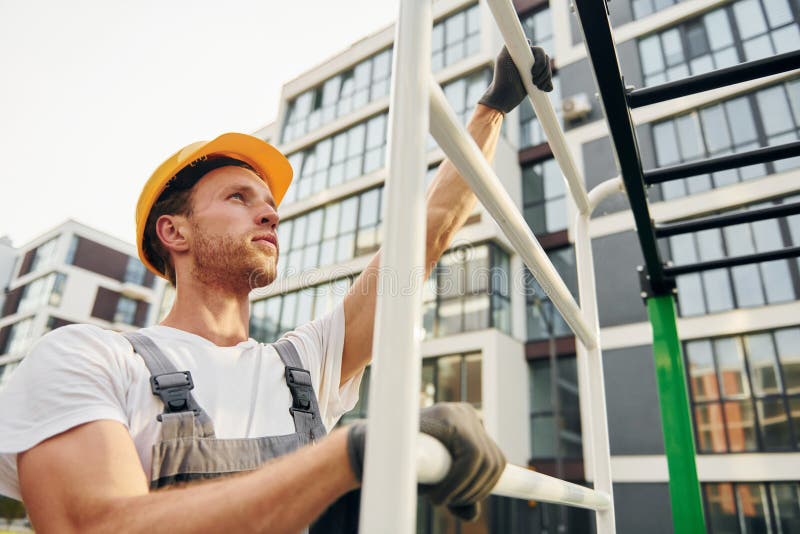 Looking Far Away. Young Man Working in Uniform at Construction at ...