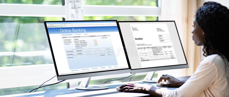 Looking at Invoice while Doing Online Banking on Computer Stock Photo ...