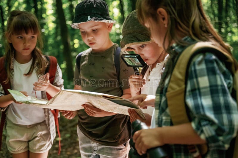 Looking at the Map. Kids in Forest at Summer Daytime Together Stock ...