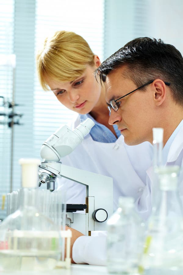 Looking in microscope stock photo. Image of handsome - 23454378