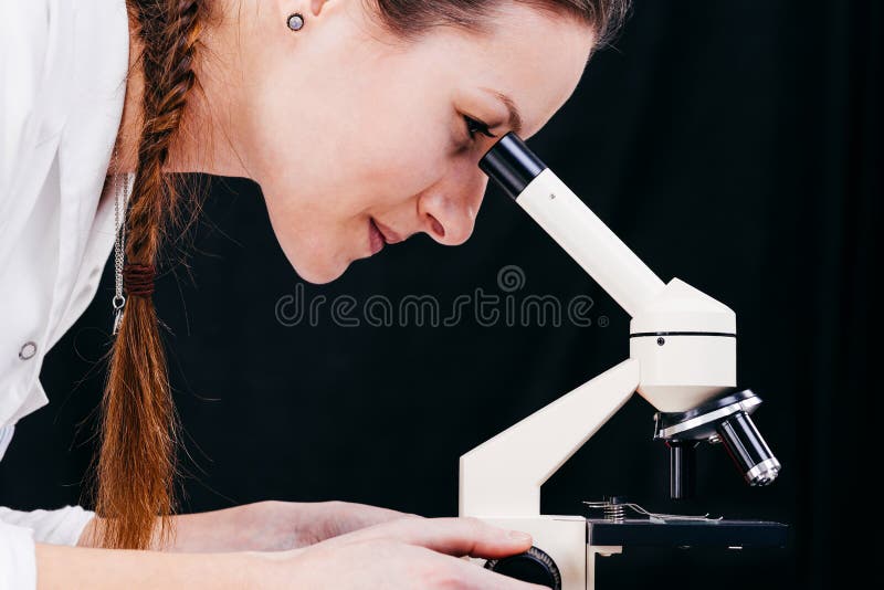 Looking through microscope stock photo. Image of student - 68219558