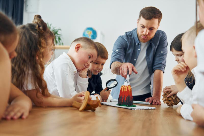 Looking at the Model of Volcano. Group of Children Students in Class at ...