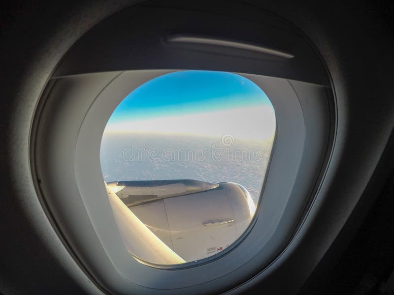 Looking Out Airplane Window and Flying Above the Clouds Stock Photo ...
