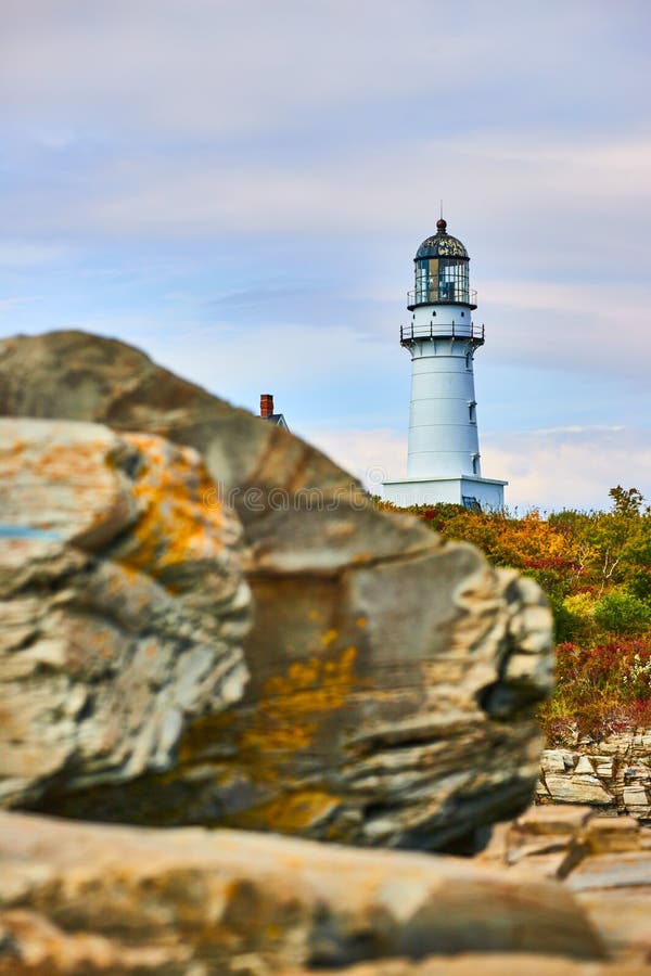 Looking Over Large Rocks with Lighthouse in the Background and Fall ...