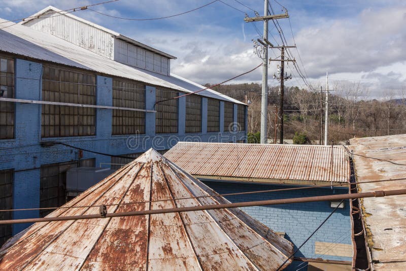Looking Over Tin Rooftops To Cloudy Skies of an Abandoned Factory ...