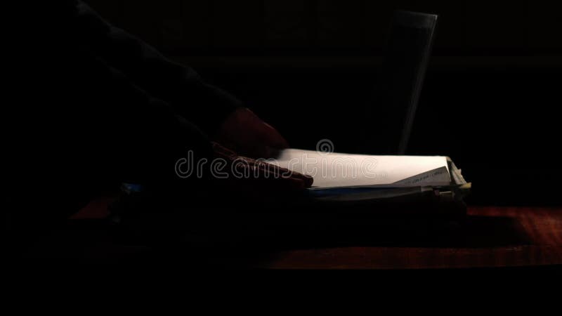 Looking at Pile of Paper Files on Desk in Dark Room Stock Footage ...