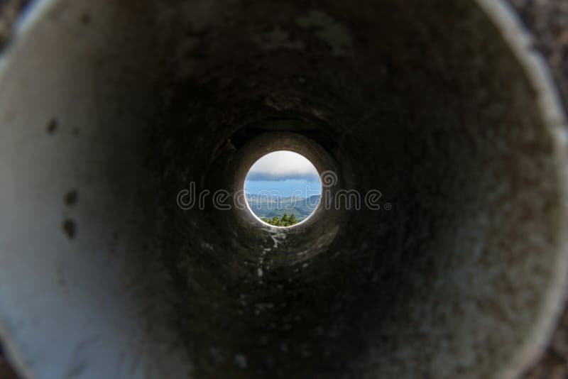 Looking through Pipe at Landscape with Hills and Ocean Stock Image ...