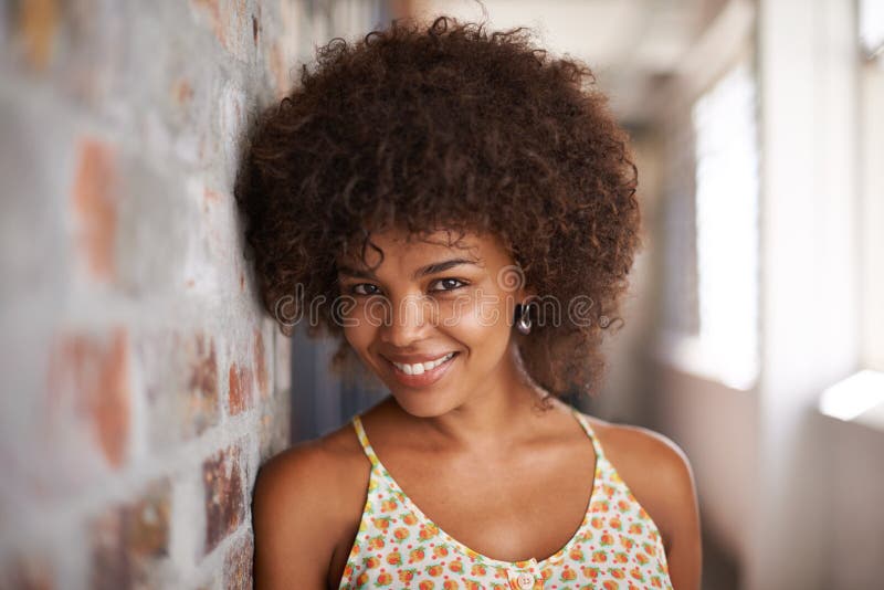 Looking Positive. Portrait of an Attractive Young Woman Standing Next ... Looking Positive. Portrait of an Attractive Young Woman Standing Next ...