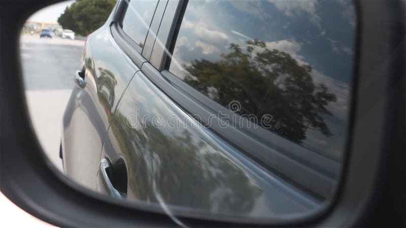 A Looking in the Rearview Mirror while Driving on the Highway Stock ...