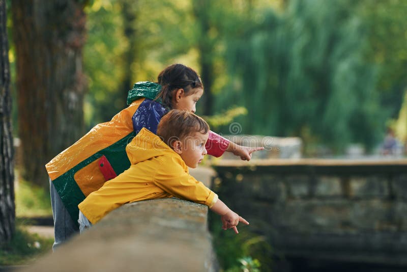 Looking at the River. Kids Having Fun Outdoors in the Park after the ...