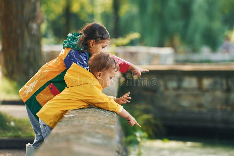 Looking at the River. Kids Having Fun Outdoors in the Park after the ...