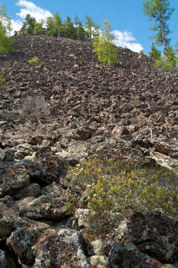 Looking between a Rock and Trees at Some Mountains Stock Image - Image ...