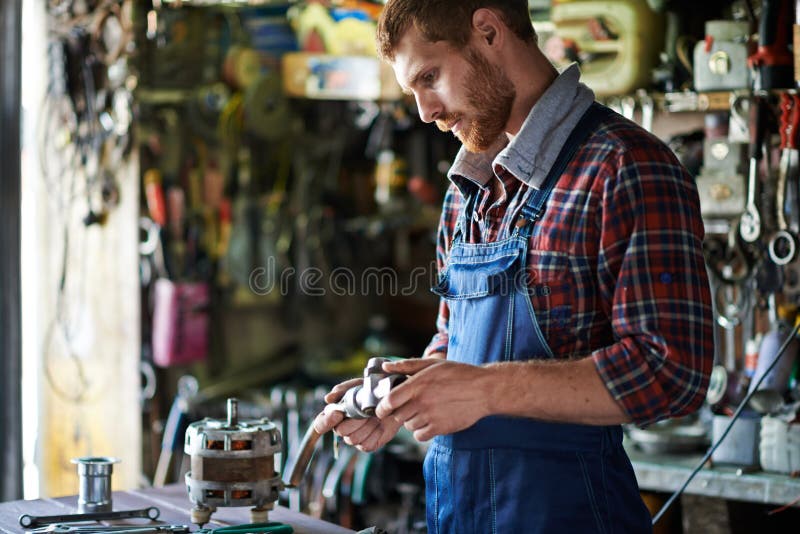Looking at spare part stock image. Image of adult, artisan - 74547215