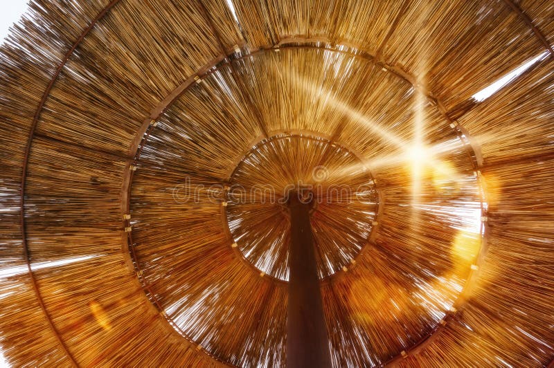 Looking through a Straw Umbrella To the Sun Stock Photo - Image of ...