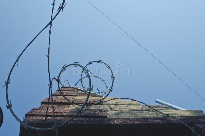 Looking Up the Barb Wire on the Wall in the Blue Sky. Stock Image ...