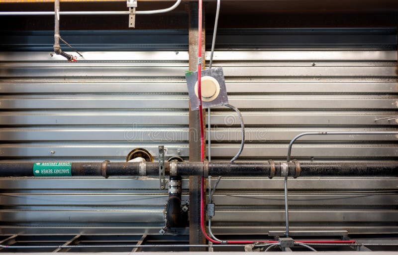 Looking Up into an Industrial Ceiling with Overhead Sewer Water Line ...