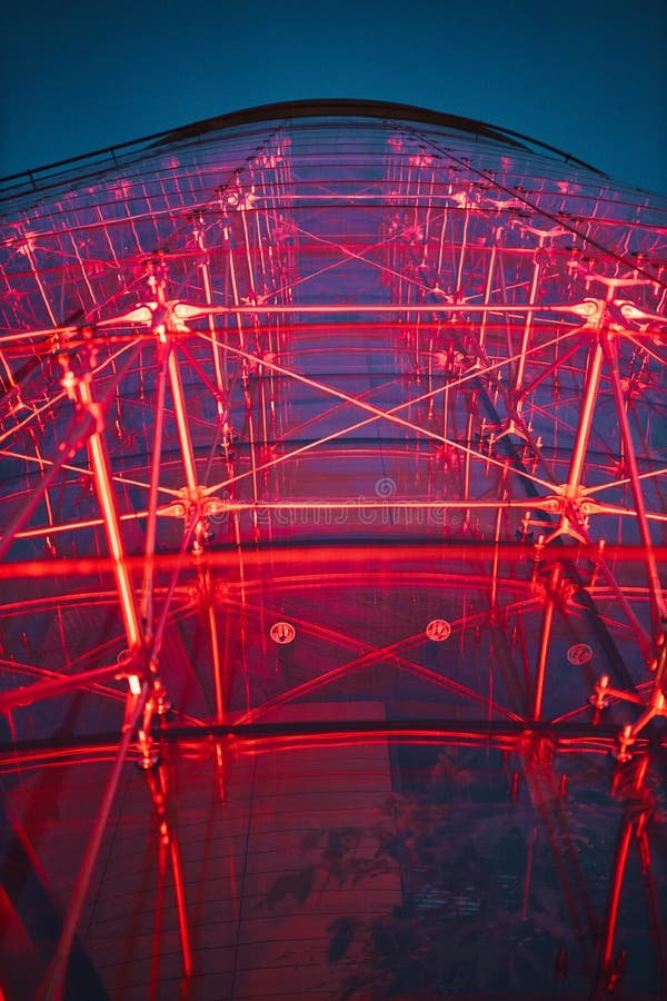 Looking Up at Modern Glass Building Lighted with Red at Night Stock ...