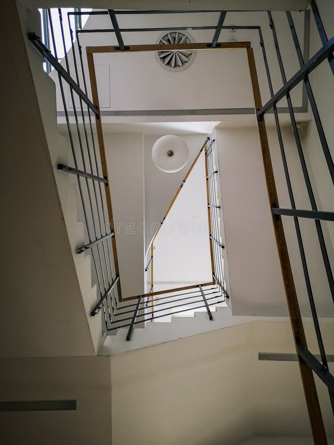 Looking Up To Rectangular Staircase with Light Wooden Handrail and ...