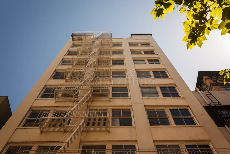 Tall Building with Fire Escape and Bay Windows Full Color Stock Photo ...
