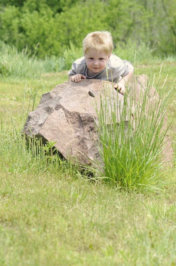 Boy climbing rock stock image. Image of looking, look - 39380397