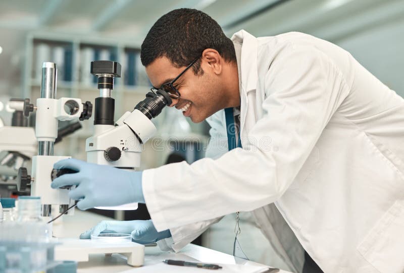 This Looks Interesting. a Young Scientist Using a Microscope in a Lab ...