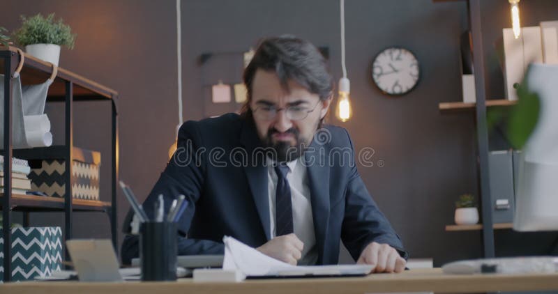 Loop of Annoyed Middle Eastern Businessman Throwing Things from Desk ...