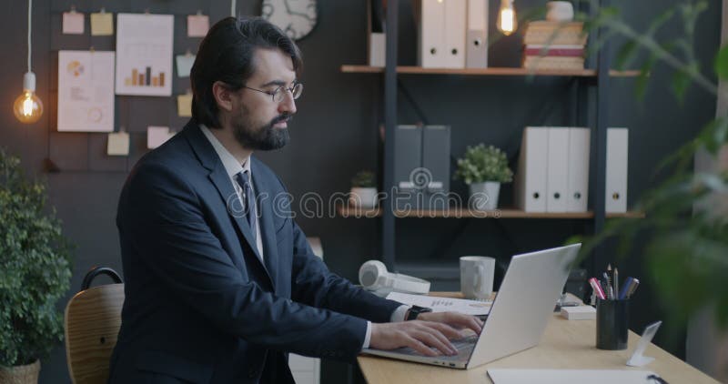 Loop of Busy Middle Eastern Employee Opening and Closing Laptop Typing ...