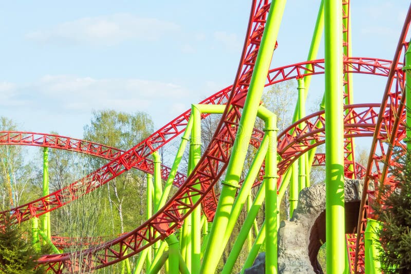 Loop and Turn on a Blue Roller Coaster in an Amusement Park. Stock ...