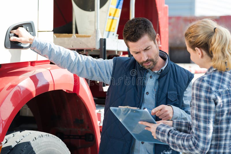 Lorry Driver Taking Instructions from Female Colleague with Clipboard ...
