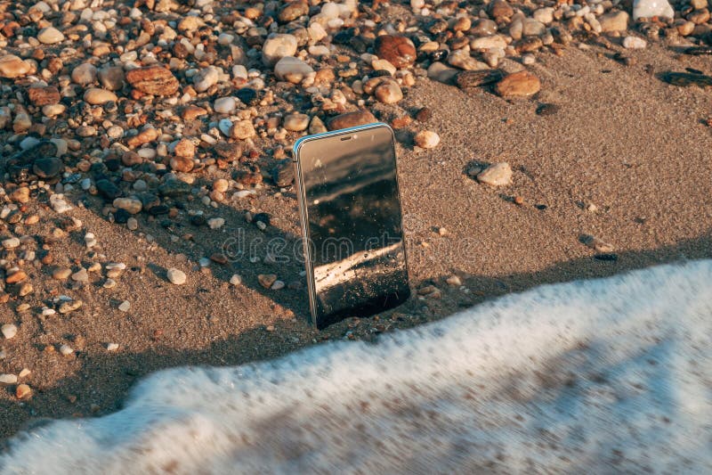 Lost Abandoned Mobile Phone Splashed by Sea Wave in Summer Morning ...