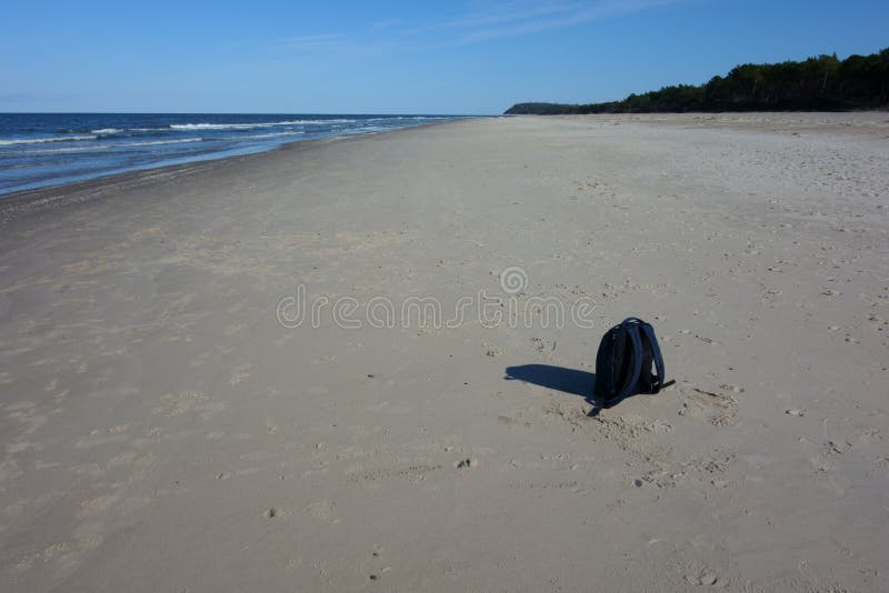 Lost Backpack on an Empty Beach Stock Image - Image of pebbles, waves ...