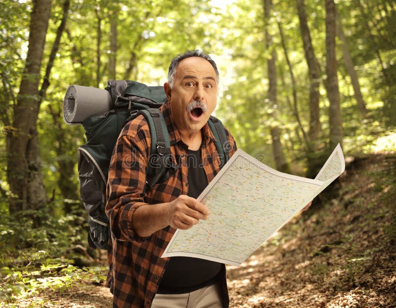 Lost Hiker Holding a Map in a Forest Stock Photo - Image of gear, hiker ...
