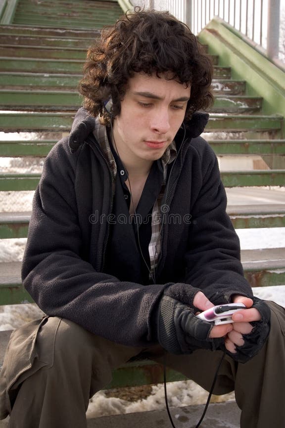 Lost in his own world stock photo. Image of listening, dark - 606340