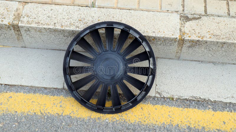 A Lost Hubcap from a Car Wheel Lies on the Side of the Road Stock Image ...