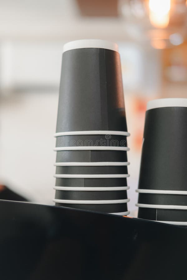 Black Drinking Paper Coffee Cups in Piles on Coffee Machine Stock Image ...