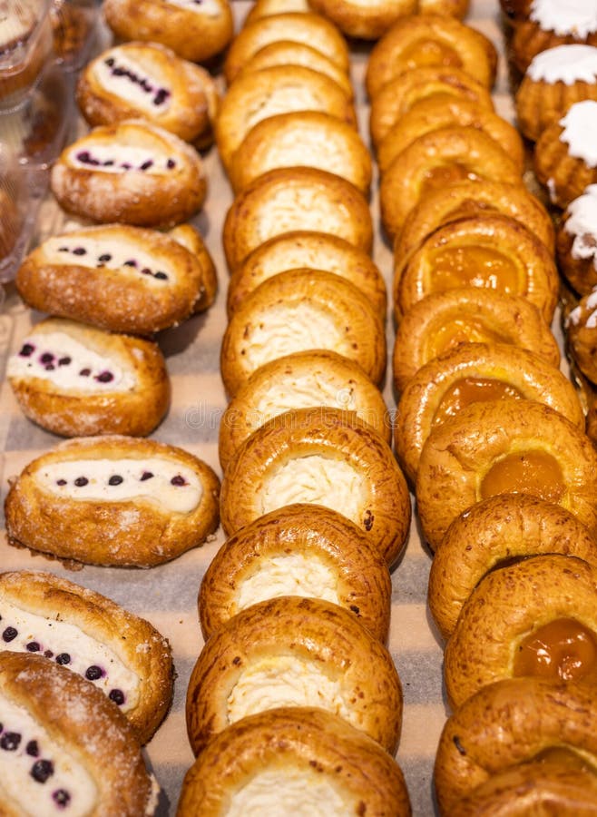 A Lot of Buns with Different Fillings and Toppings are on the Counter ...