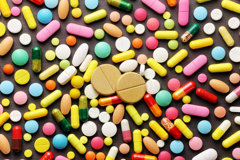 A Lot of Colorful Pills in Spoon on a Blue Background Stock Photo ...